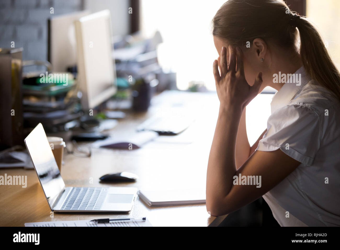 Tired female feel unwell suffering from headache at work Stock Photo ...