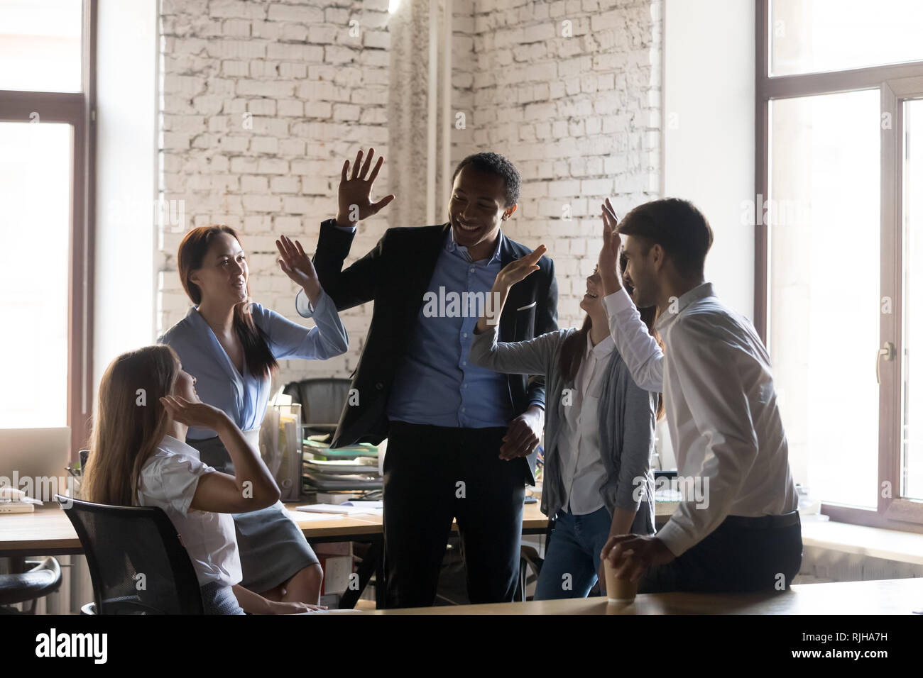 Excited employee give high five celebrating shared success Stock Photo ...
