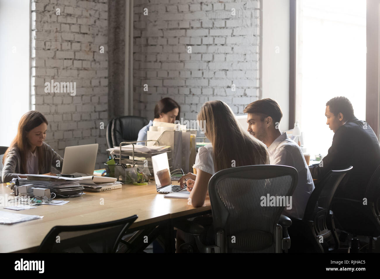 Diverse colleagues busy brainstorming hi-res stock photography and ...