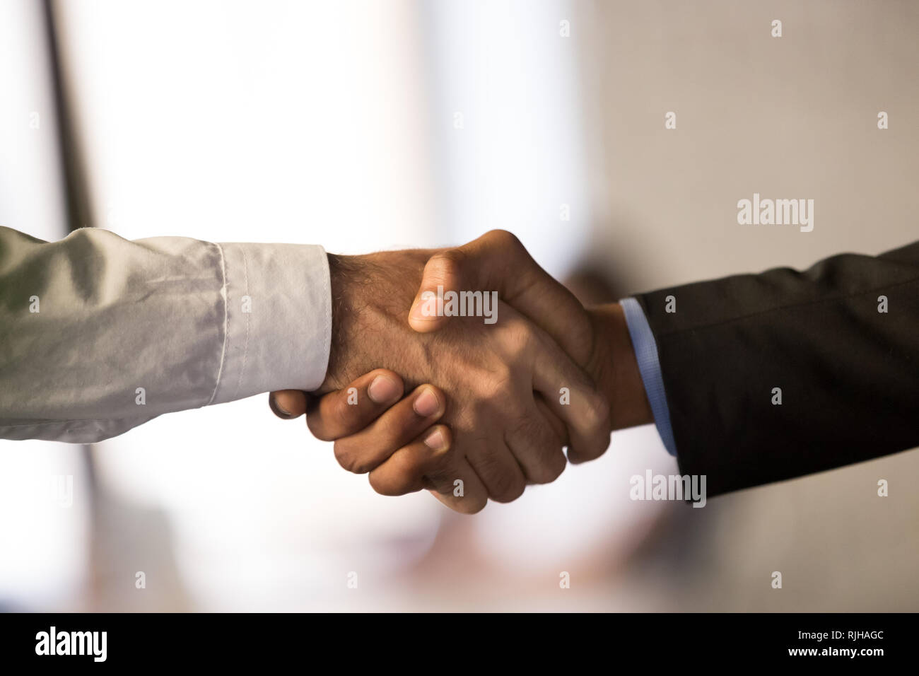 Close up of male employees handshake closing deal Stock Photo - Alamy