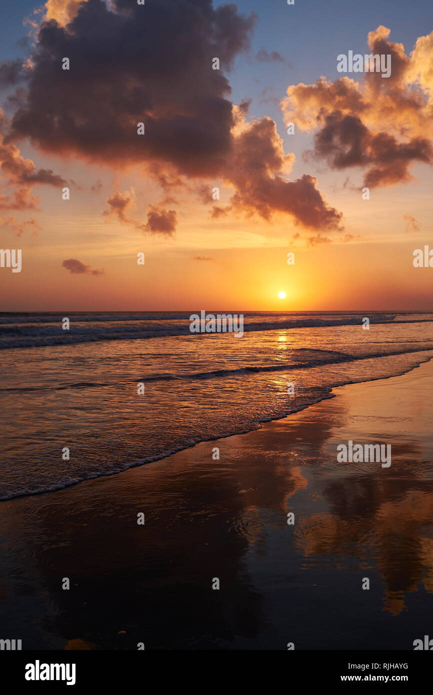 Sunset over beach in Seminyak, Bali, Indonesia Stock Photo - Alamy