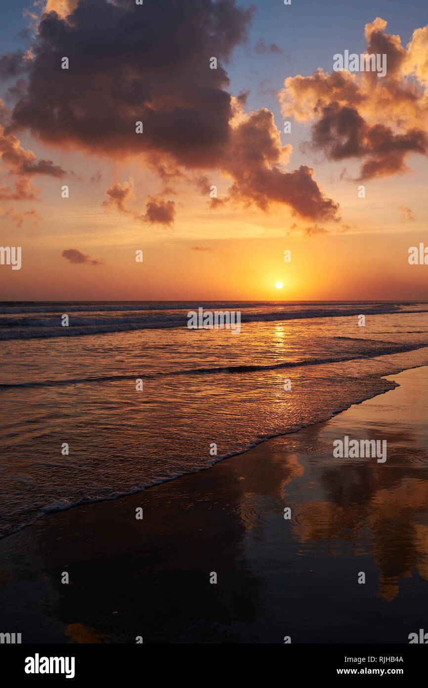 Sunset over beach in Seminyak, Bali, Indonesia Stock Photo - Alamy