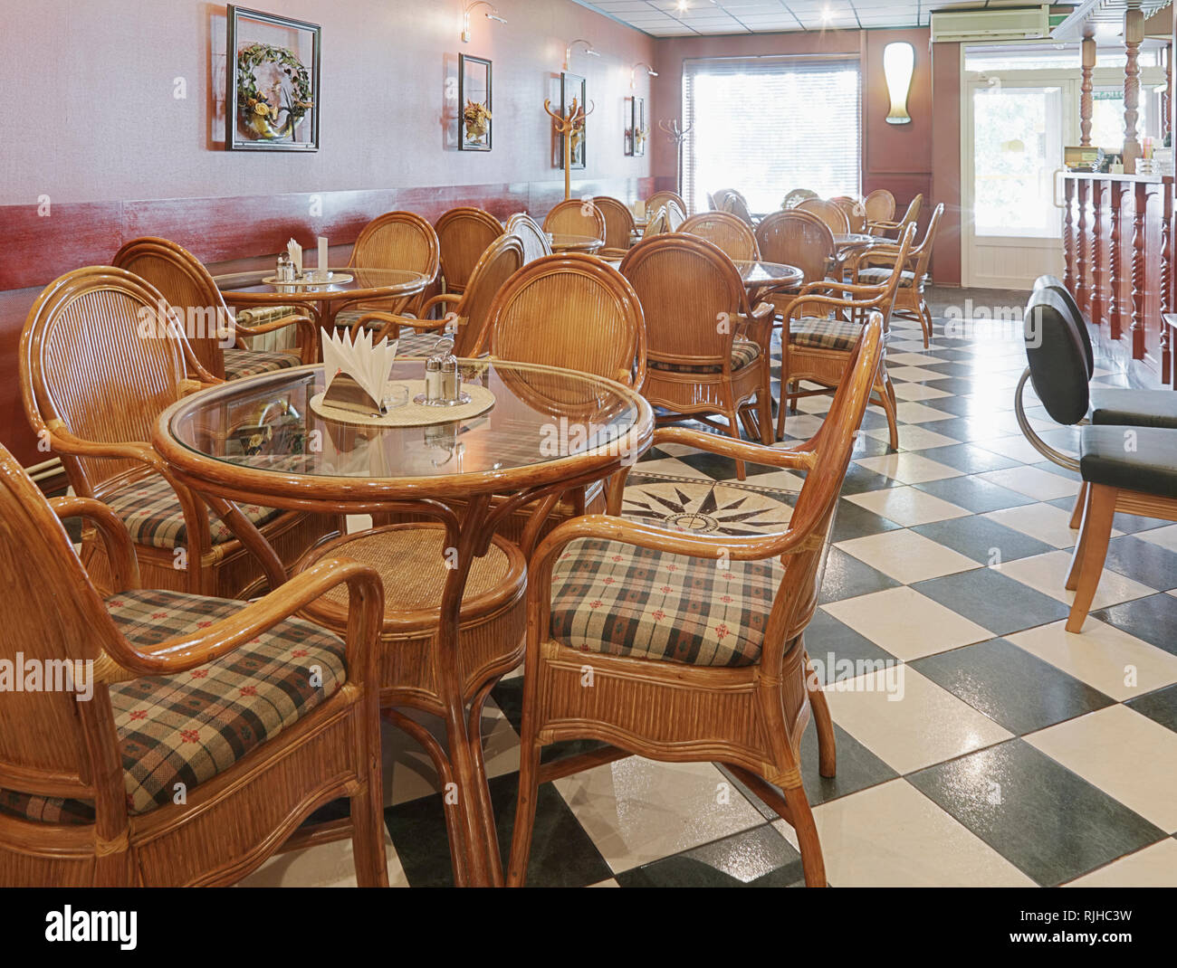Tables and chairs in empty restaurant Stock Photo - Alamy