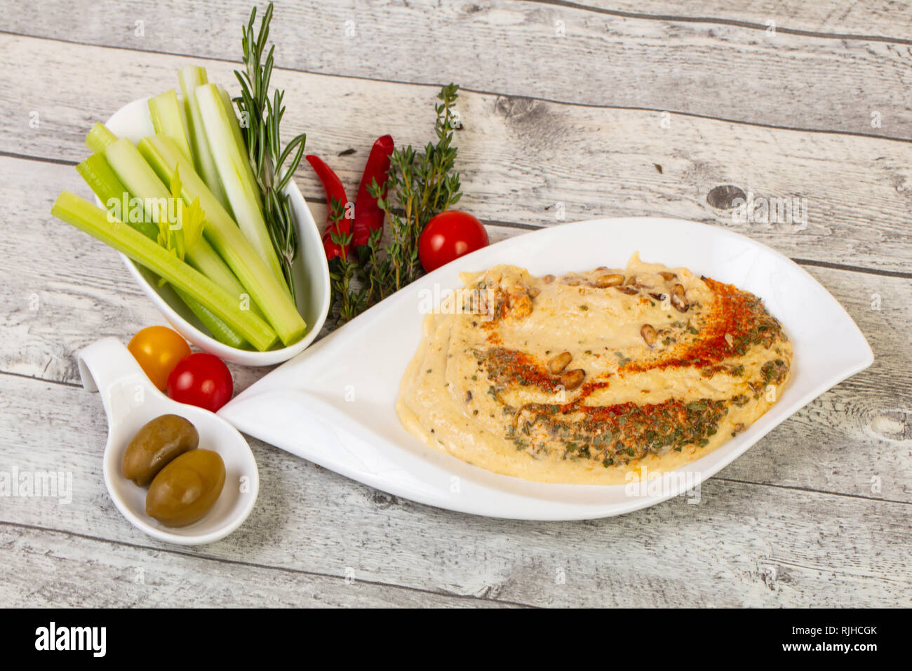Vegan cuisine - Humus with celery sticks Stock Photo - Alamy