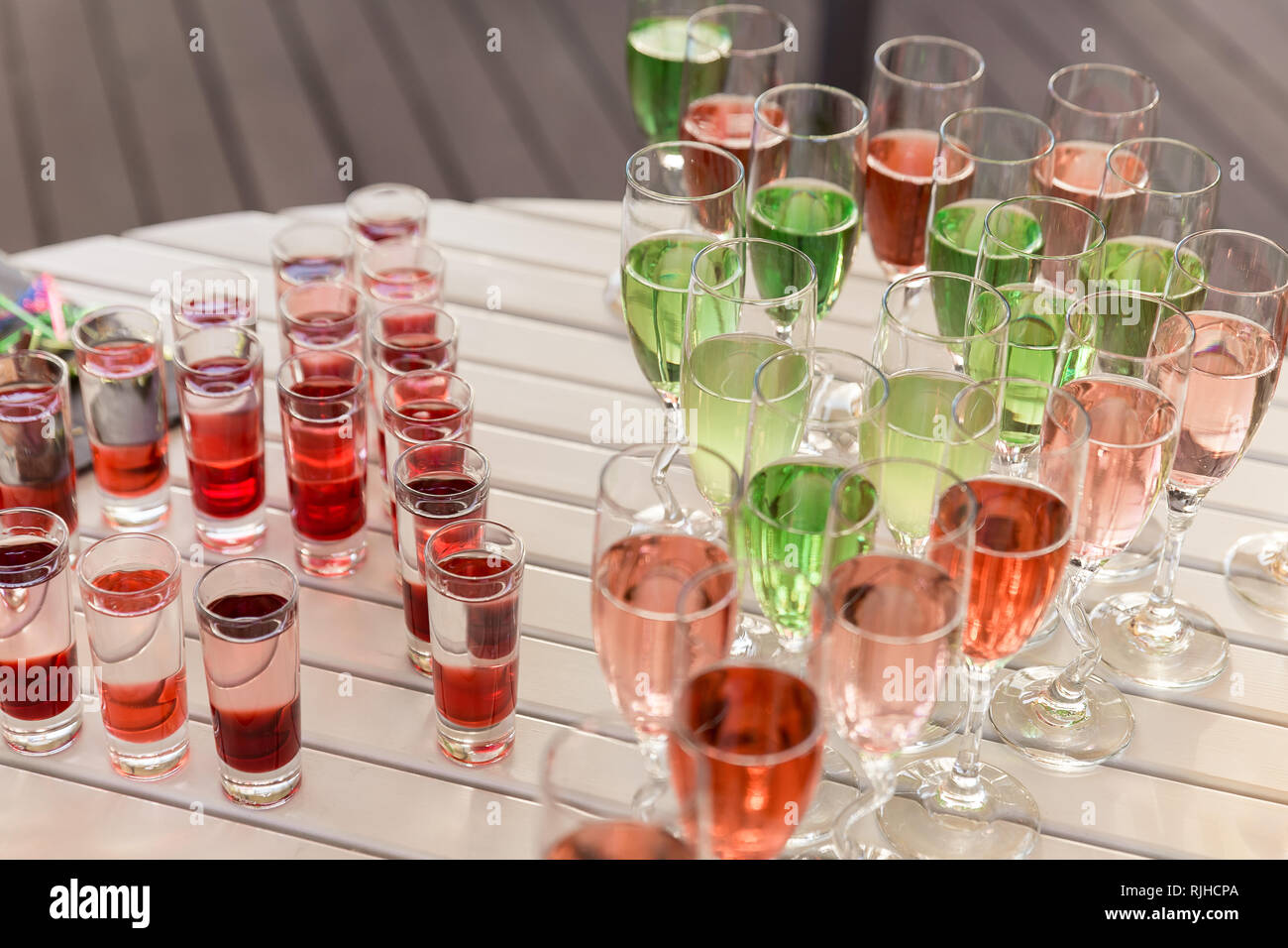 lot of colorful drinks on white buffet table, catering Stock Photo - Alamy