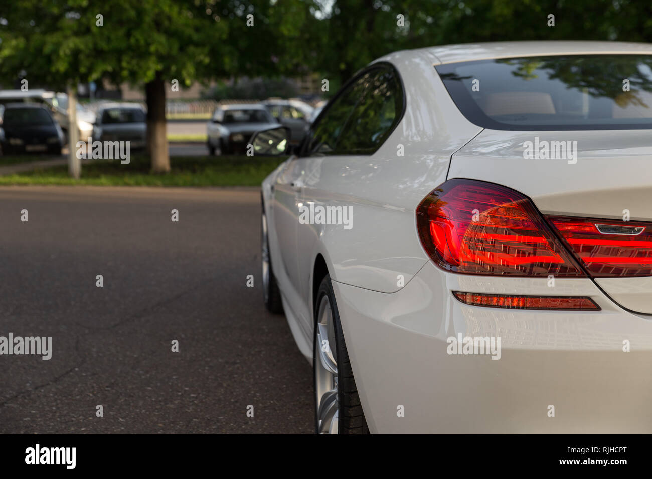 Back side of white luxury beautiful car outdoor Stock Photo - Alamy