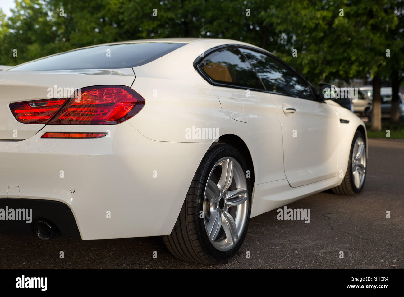 Back side of white luxury beautiful car outdoor Stock Photo - Alamy