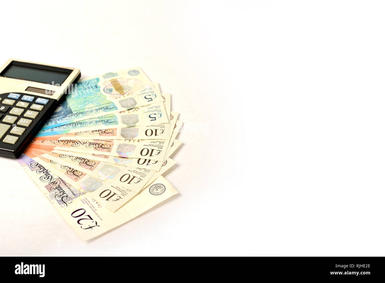 Pound paper money and calculator are isolated on white background Stock ...