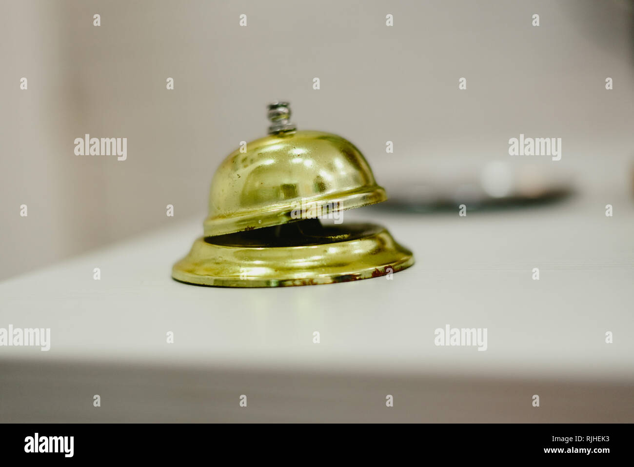 Gold hotel concierge bell hi-res stock photography and images - Alamy