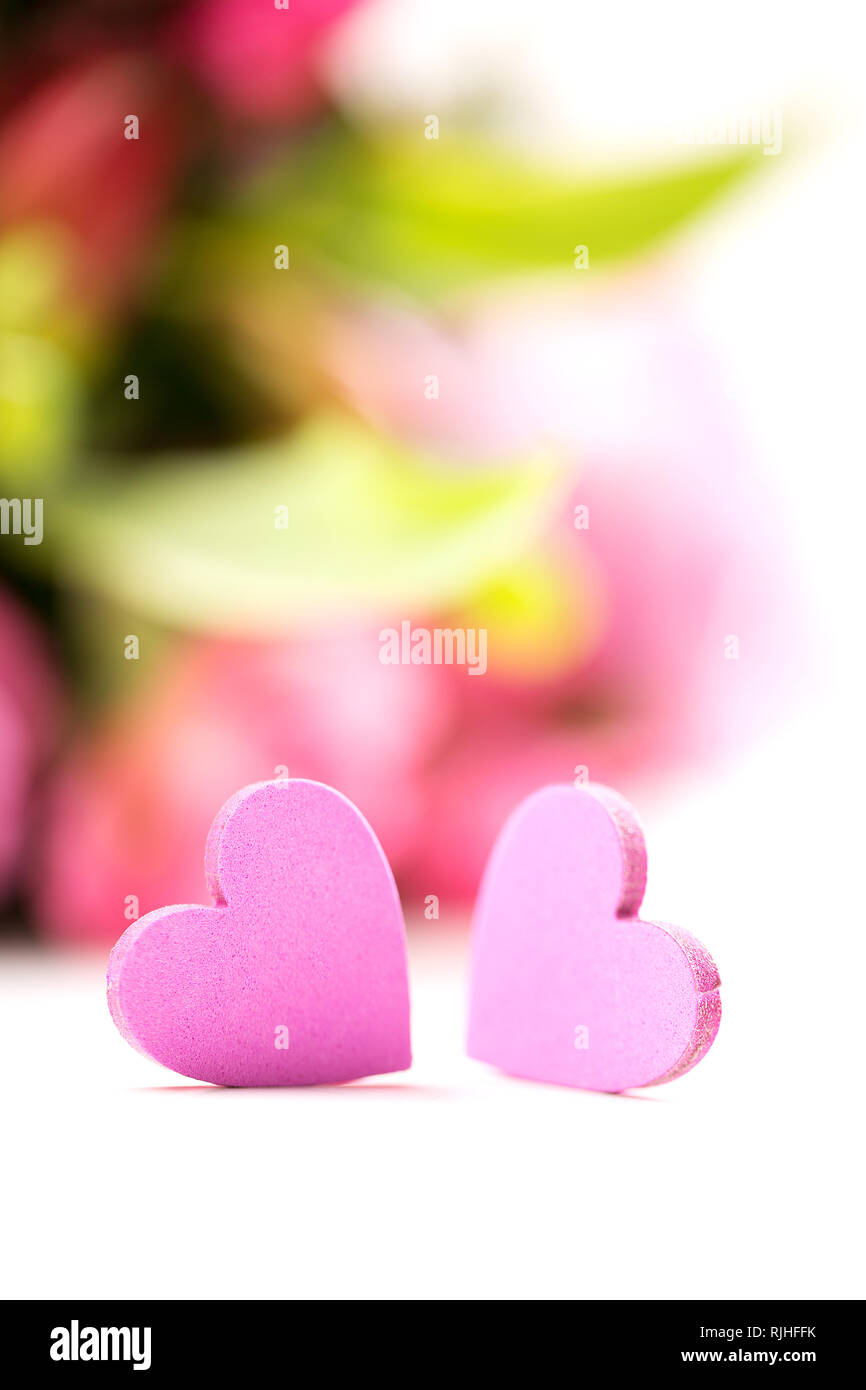 two hearts in front of roses on white background Stock Photo - Alamy