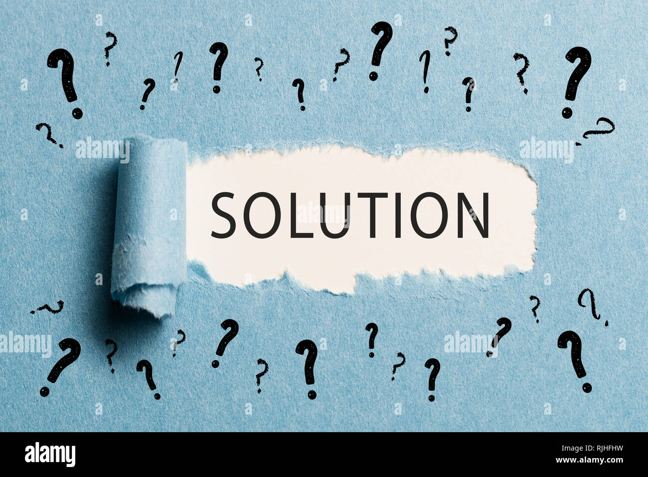 torn paper revealing the word "solution Stock Photo - Alamy