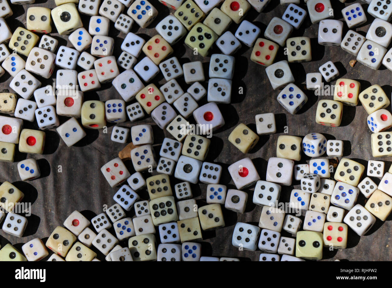 Many color dice on a table on a sunny day Stock Photo - Alamy