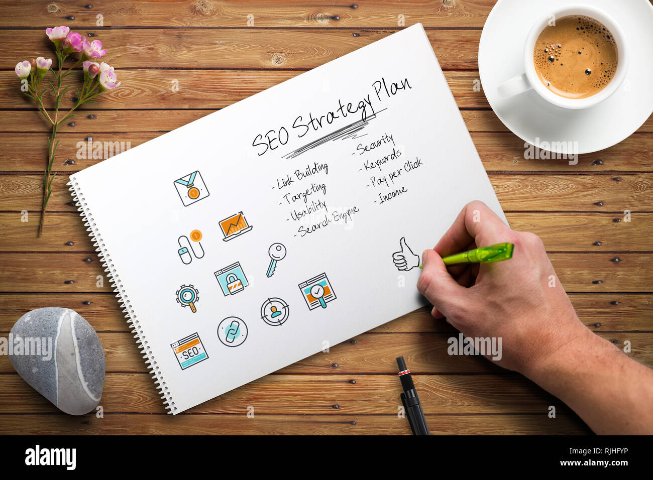 hand is writing a SEO strategy at a computer workplace Stock Photo - Alamy