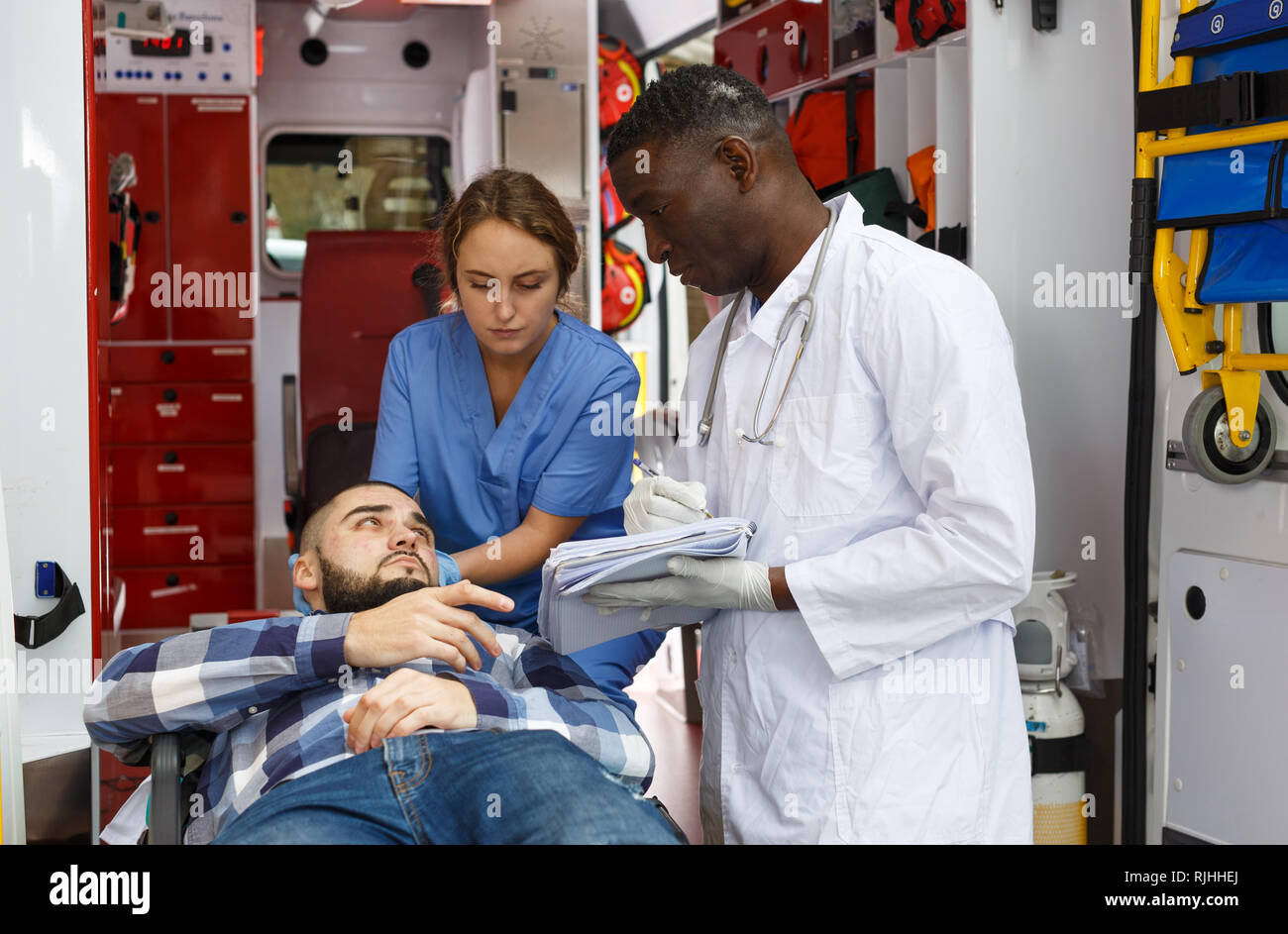 Paramedic giving patient logbook for signature in ambulance auto Stock ...