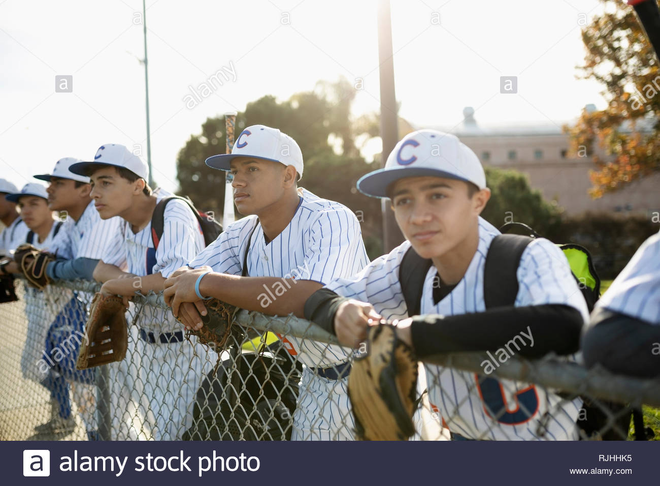 Boy leaning on fence in hi-res stock photography and images - Alamy