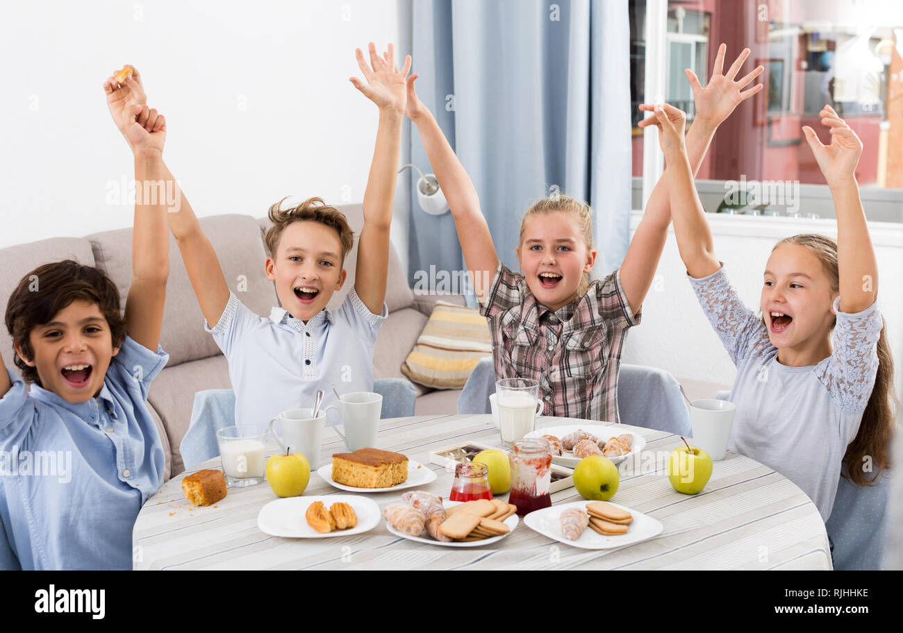 Group of children drinking tea with cookie, cake and chocolates Stock ...