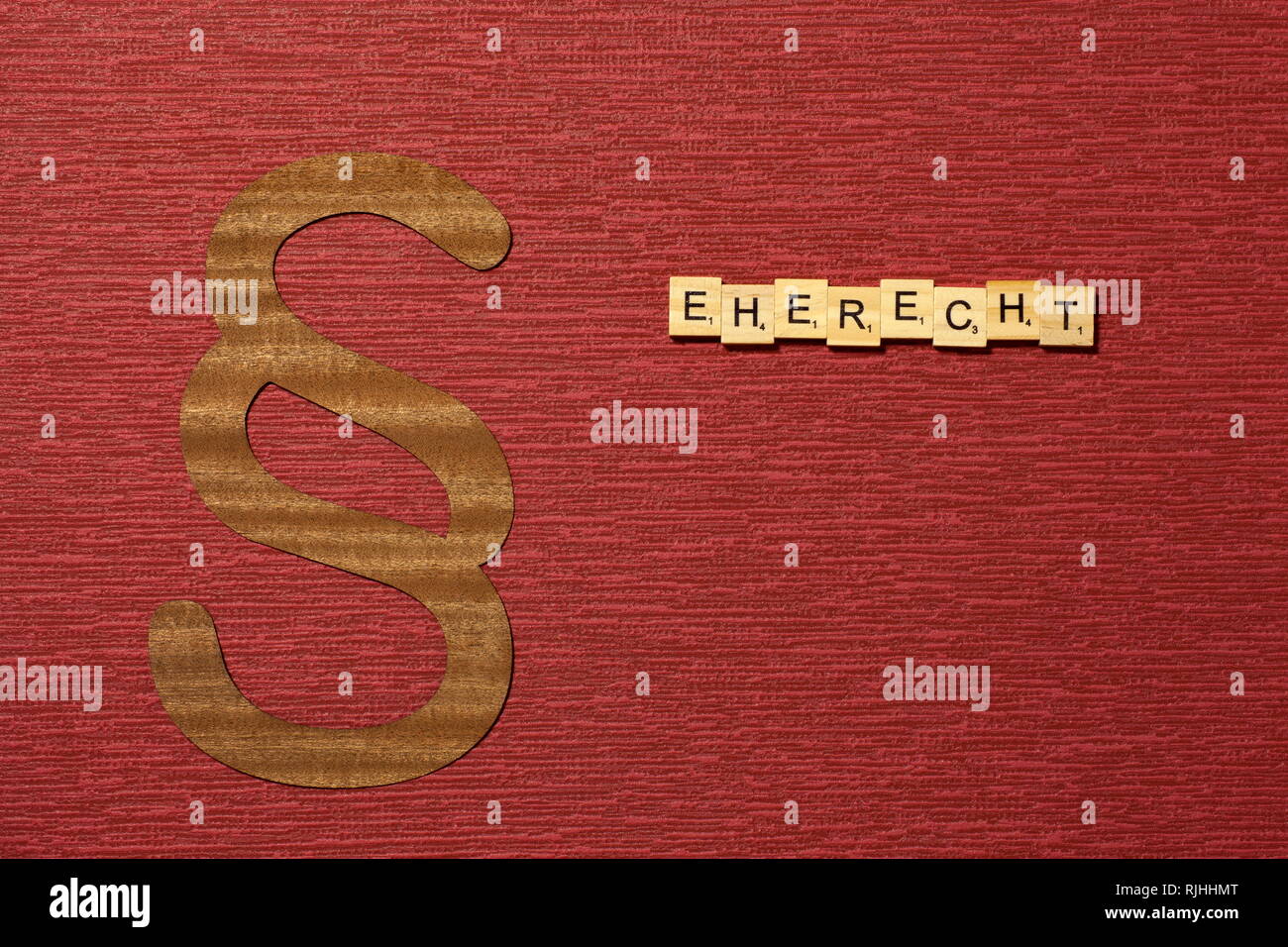 The sign paragraph on the claret color background. Its on the table ...