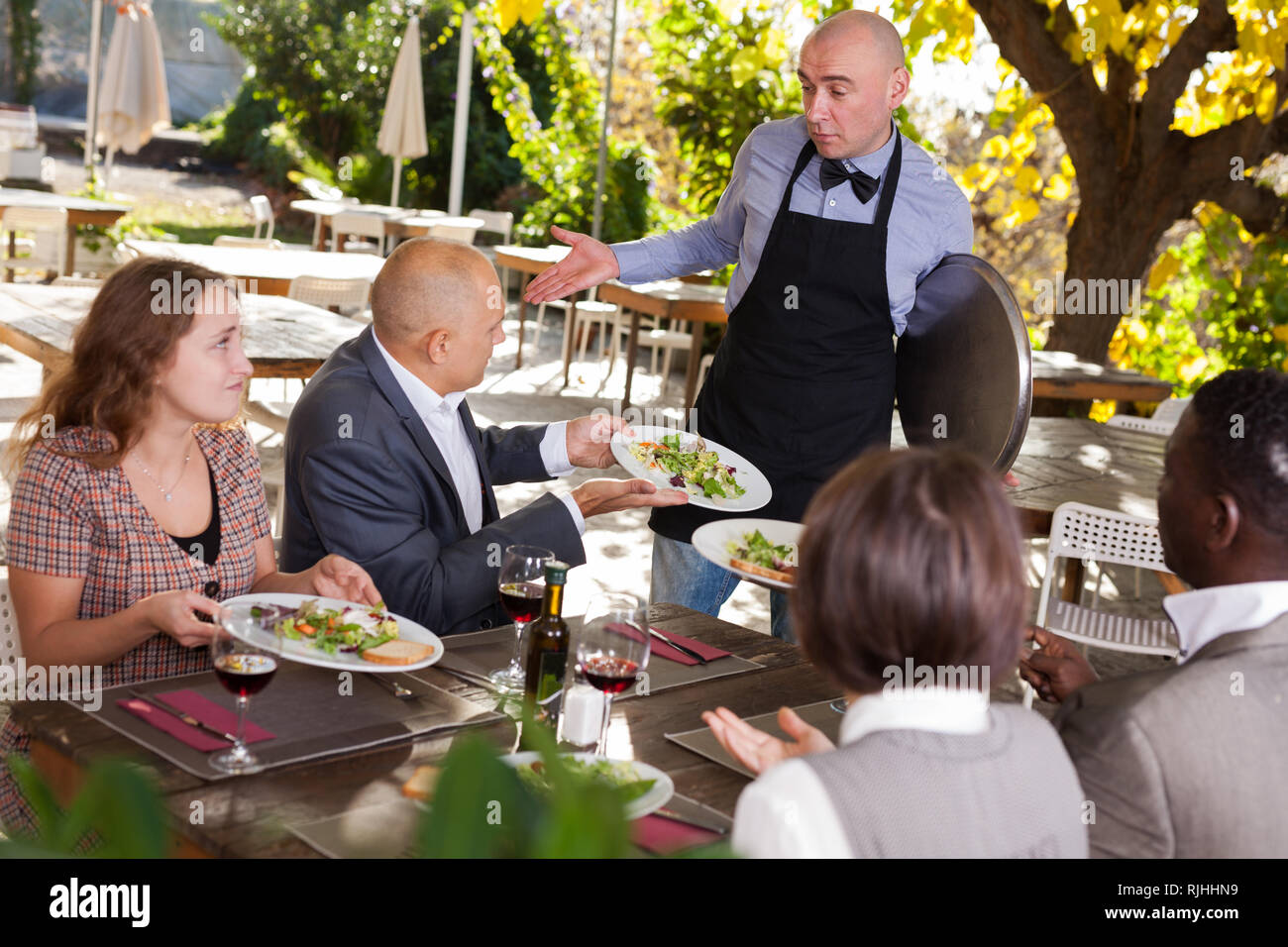 Conflict between waiter and client in the open-air restaurant Stock ...