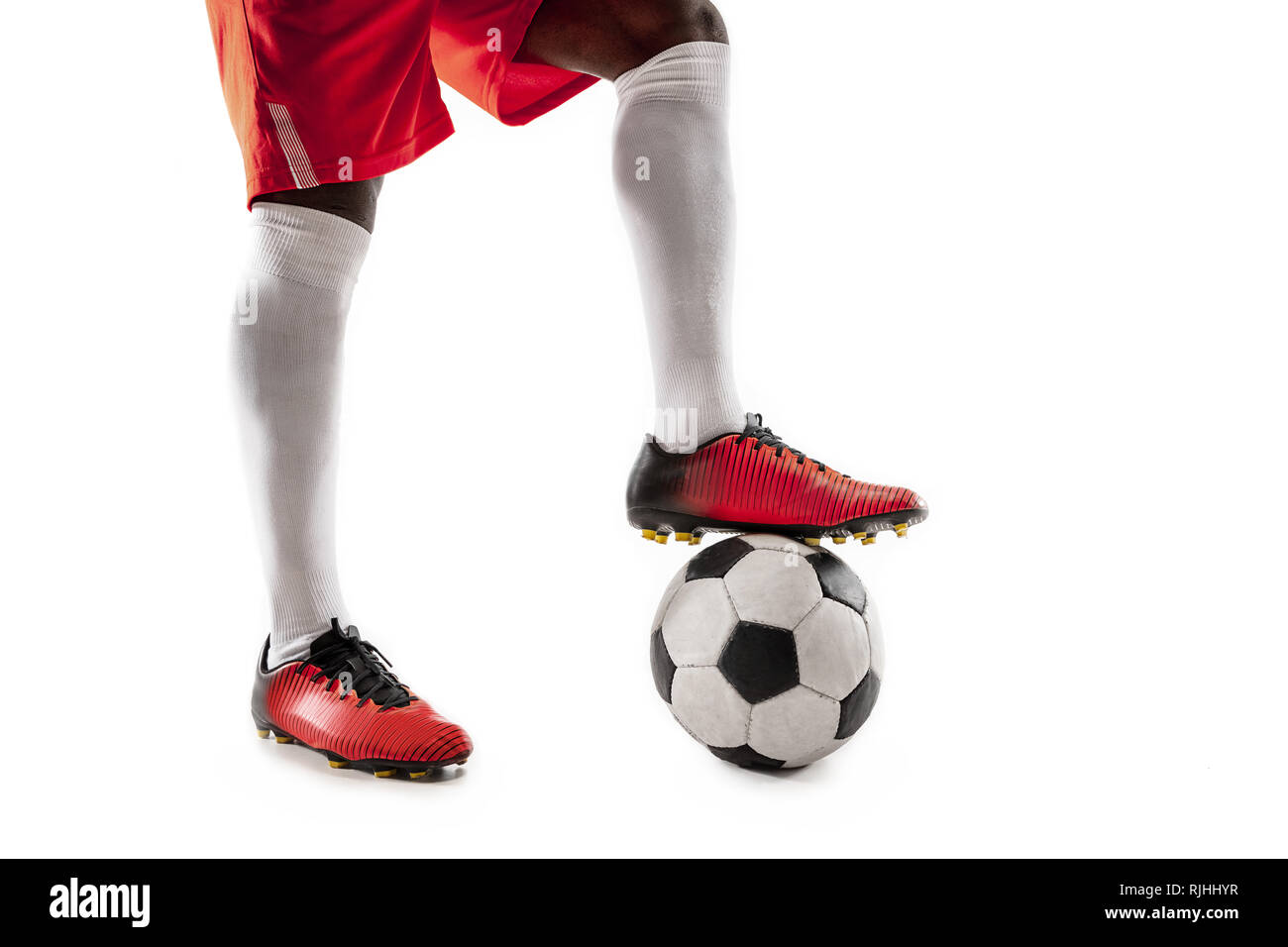 The legs of soccer player close-up isolated on white. African american ...
