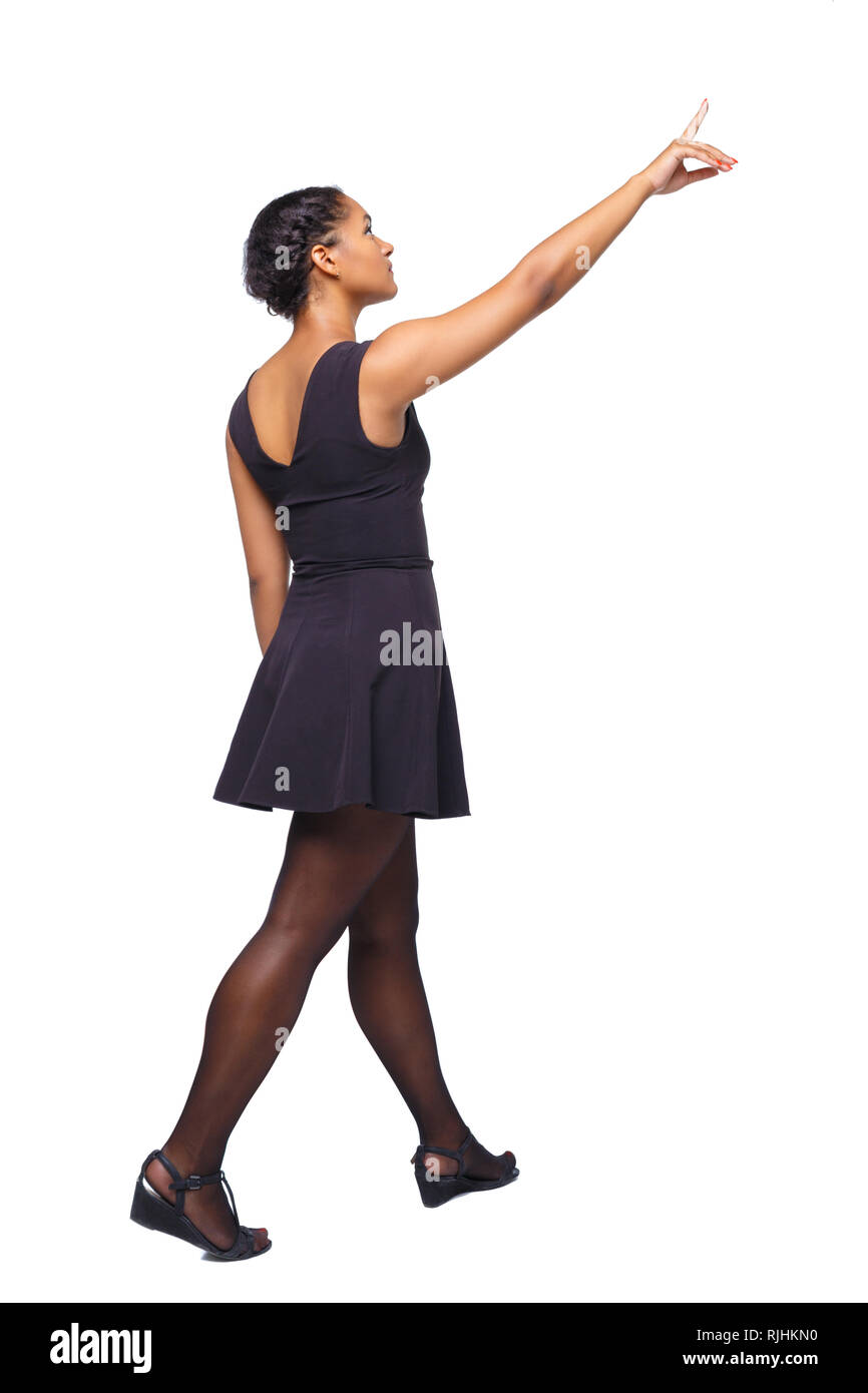 Back view of walking young black girl. going girl showing. backside ...