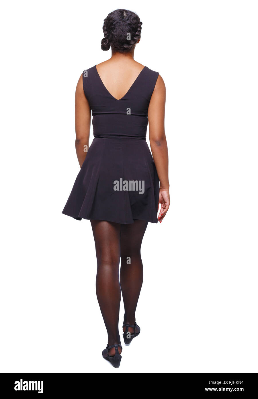 back view of a young black girl walking in dress. beautiful girl in ...
