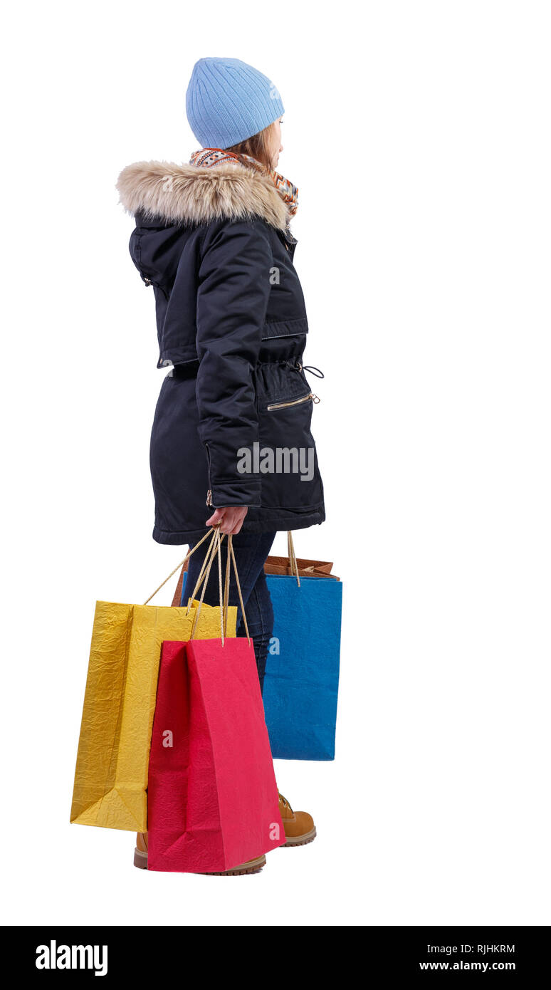 Side view of woman in winter jacket with shopping bags. backside view ...