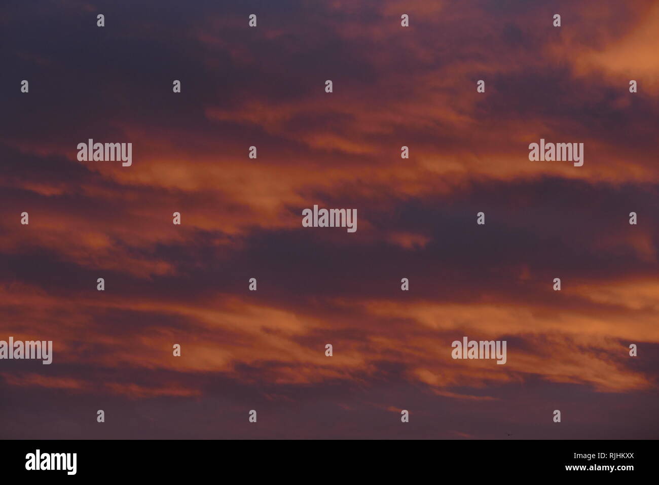 Fire-red lightly clouded sky, sunset, background Stock Photo - Alamy