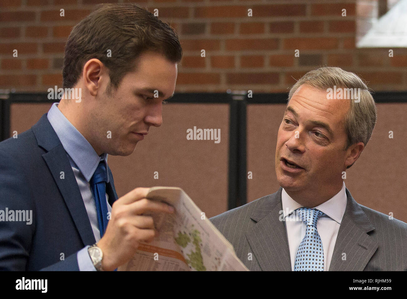 Michael Heaver and Nigel Farage look at a newspaper together before a ...
