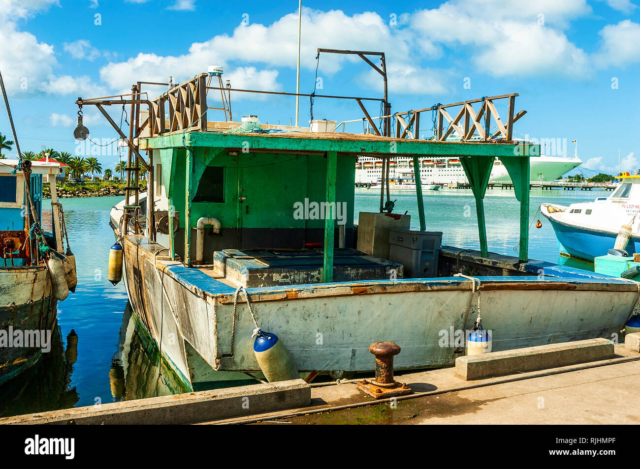 A traditional working fishing boat floating on the tranquil blue ...