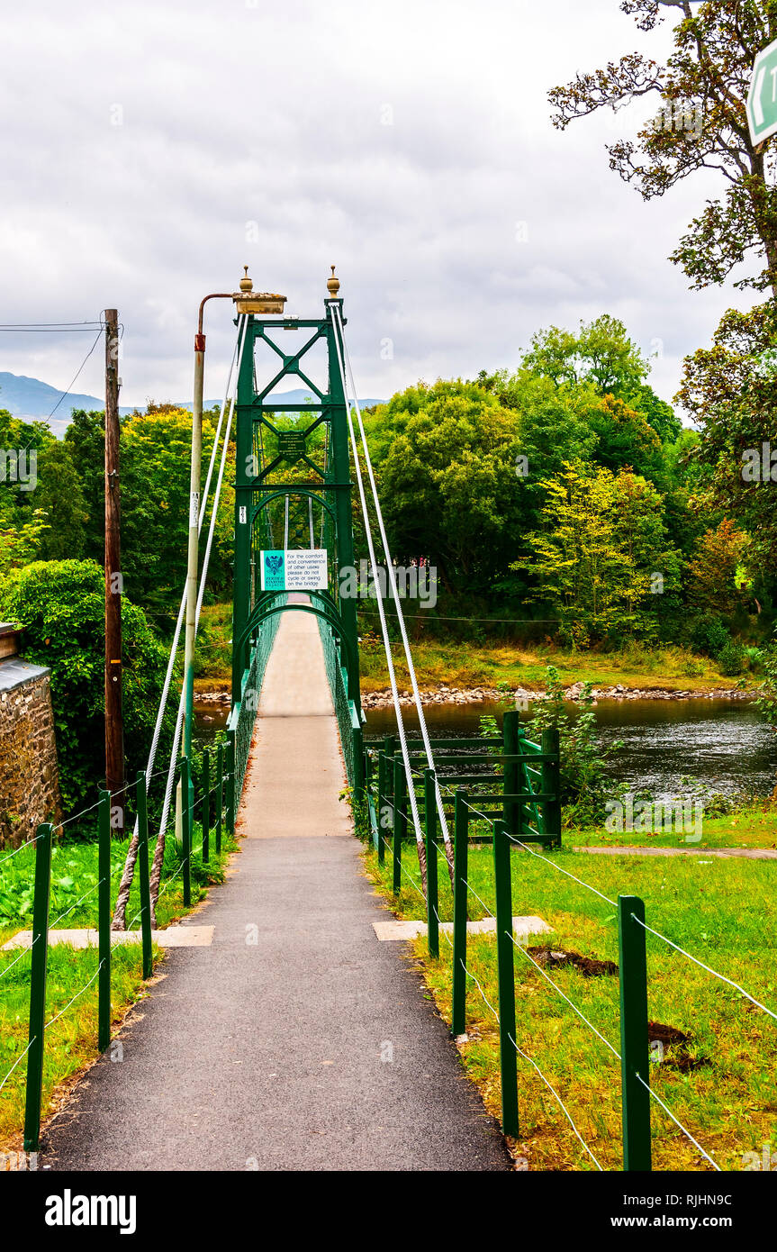 The green painted suspension footbridge constructed over the River ...