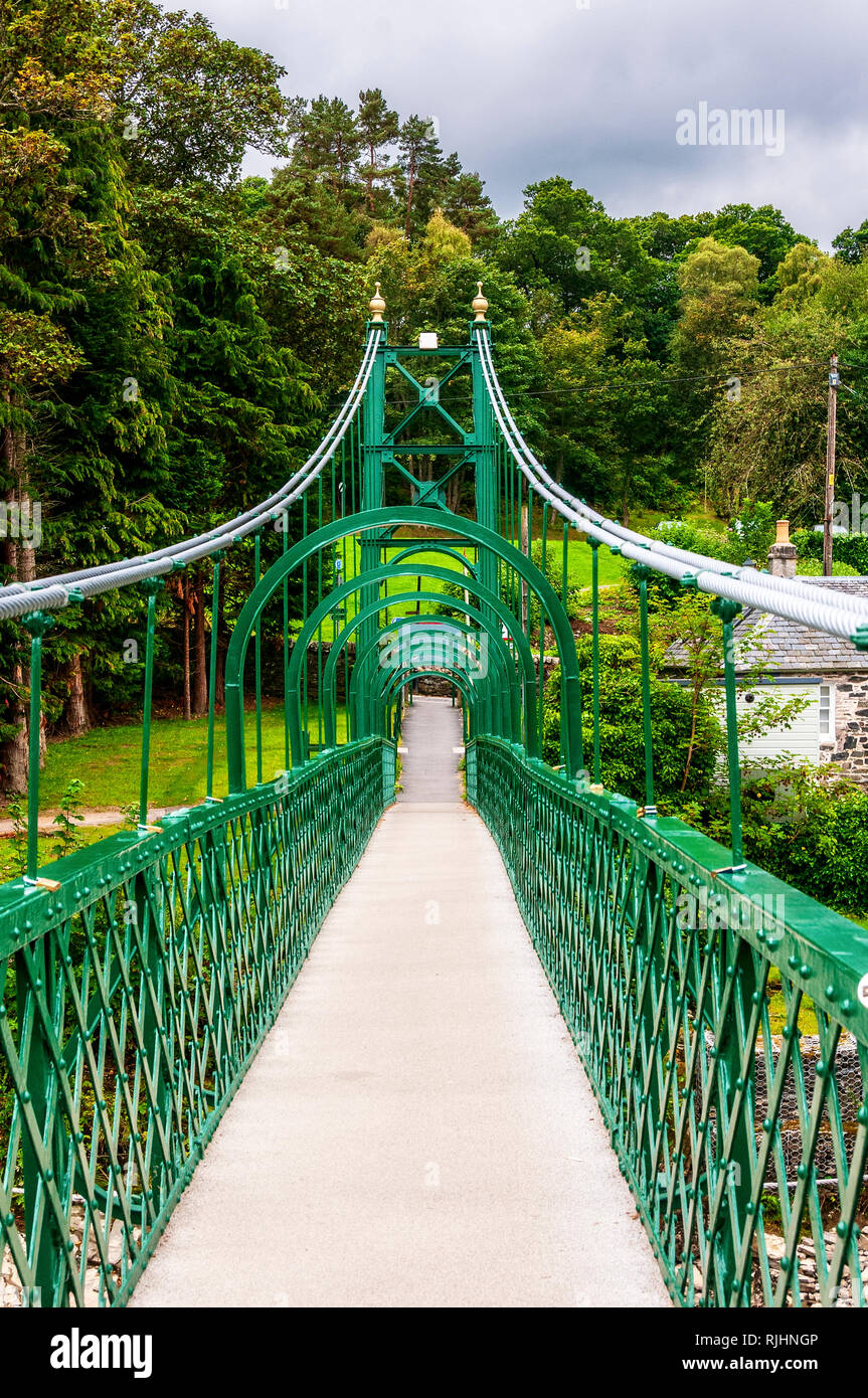 The green painted suspension footbridge constructed over the River ...