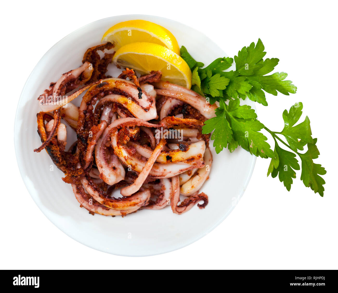 Delicious cooked squid or octopus tentacles with lemon and parsley on a ...