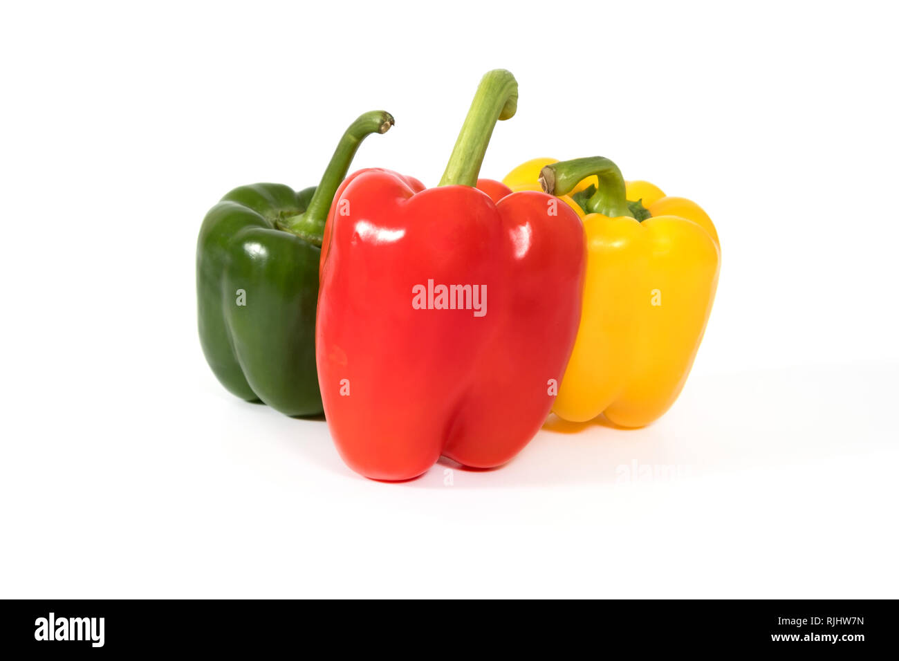 Red, yellow, green fresh and healthy peppers on white background Stock ...