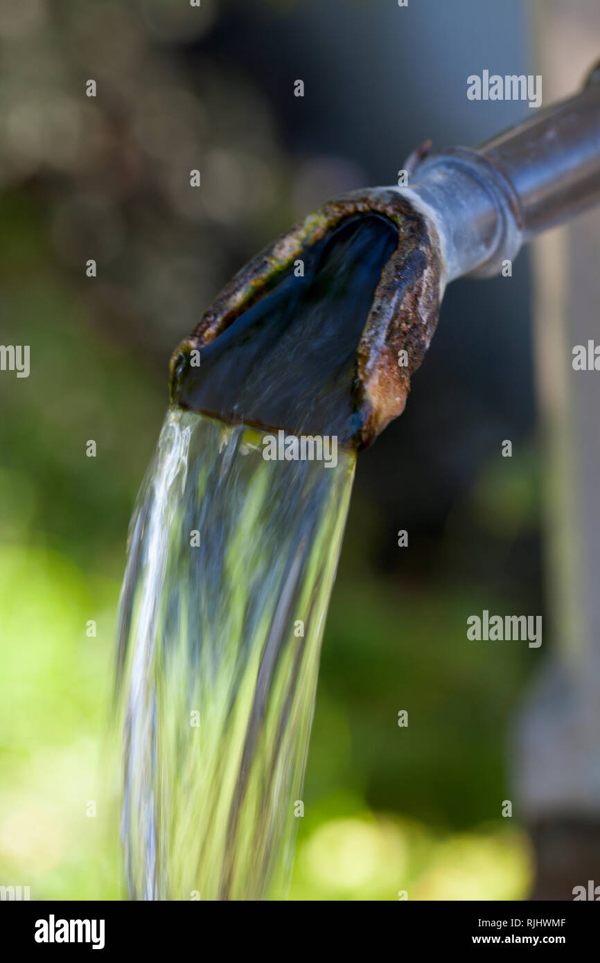 Closeup of water running from outdoor wall faucet Stock Photo - Alamy