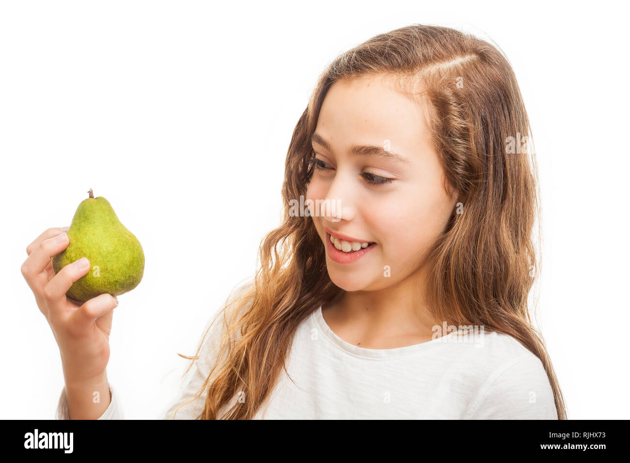 Young girl eating fruit isolated on white background Stock Photo - Alamy
