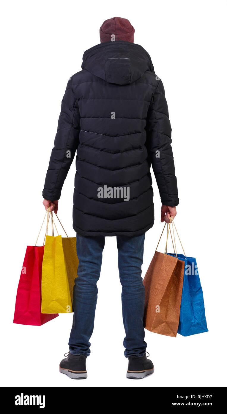 back view of man in winter jacket with shopping bags. backside view of ...