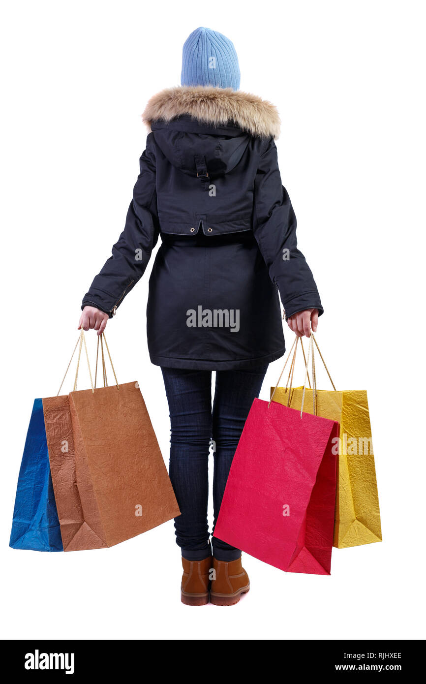 back view of woman in winter jacket with shopping bags. beautiful ...