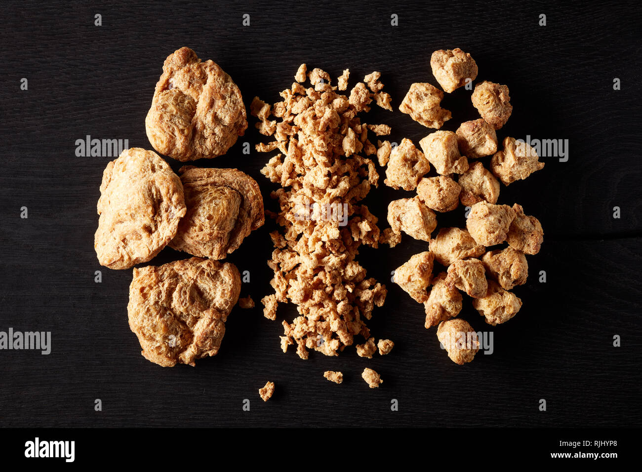 Different types of soya chunks on black background, top view Stock ...