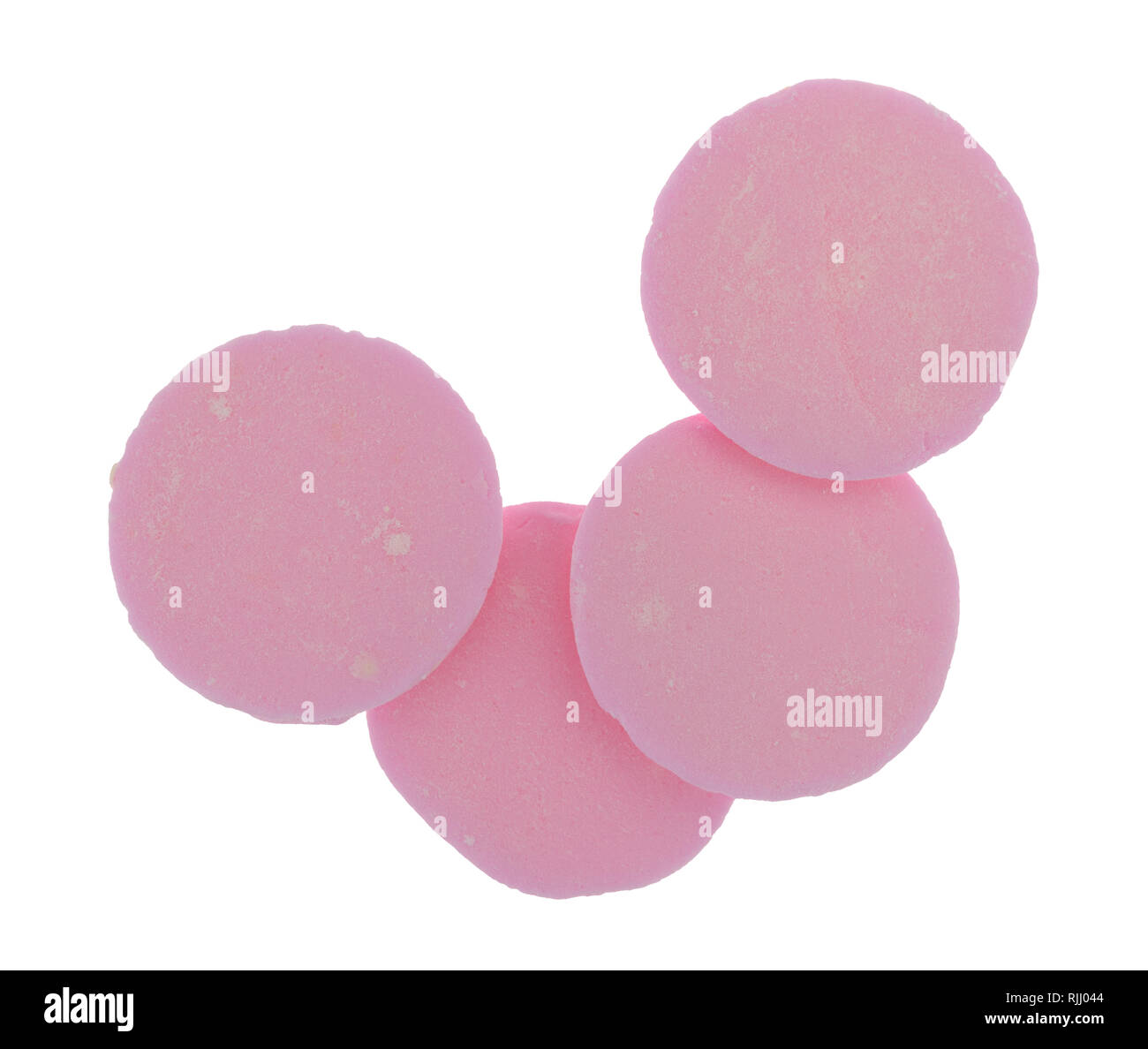 Top view of four thin colorful round pink flavor candy wafers isolated ...