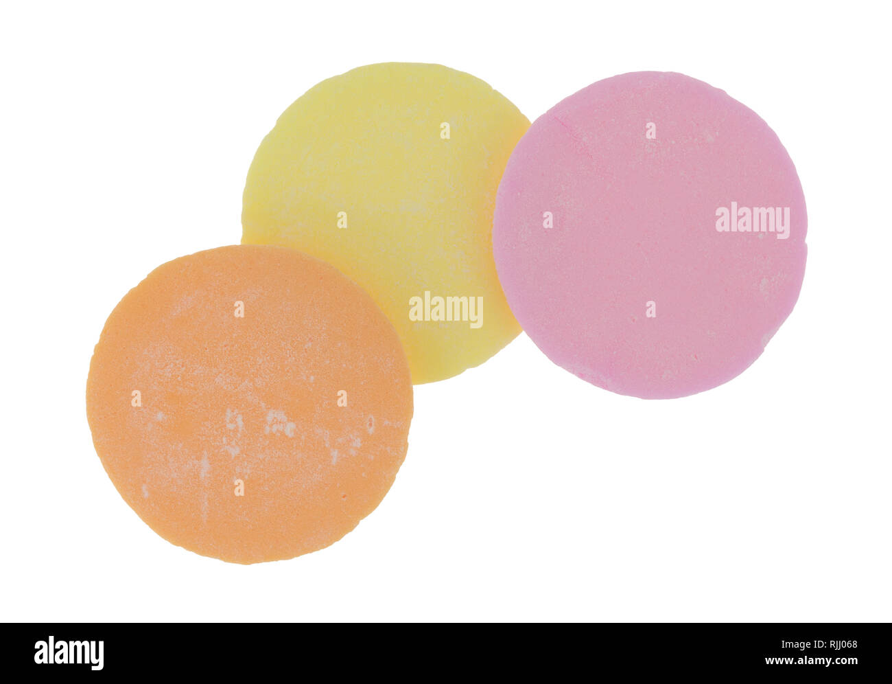 Top view of three thin colorful candy wafers isolated on a white ...