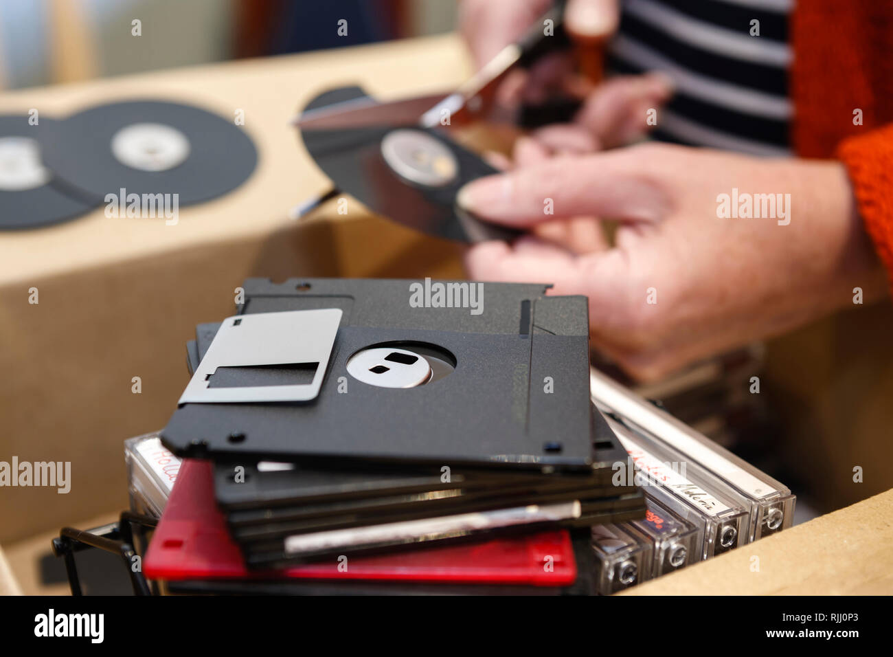 Cutting up old floppy disc with scissors to destroy information Stock ...