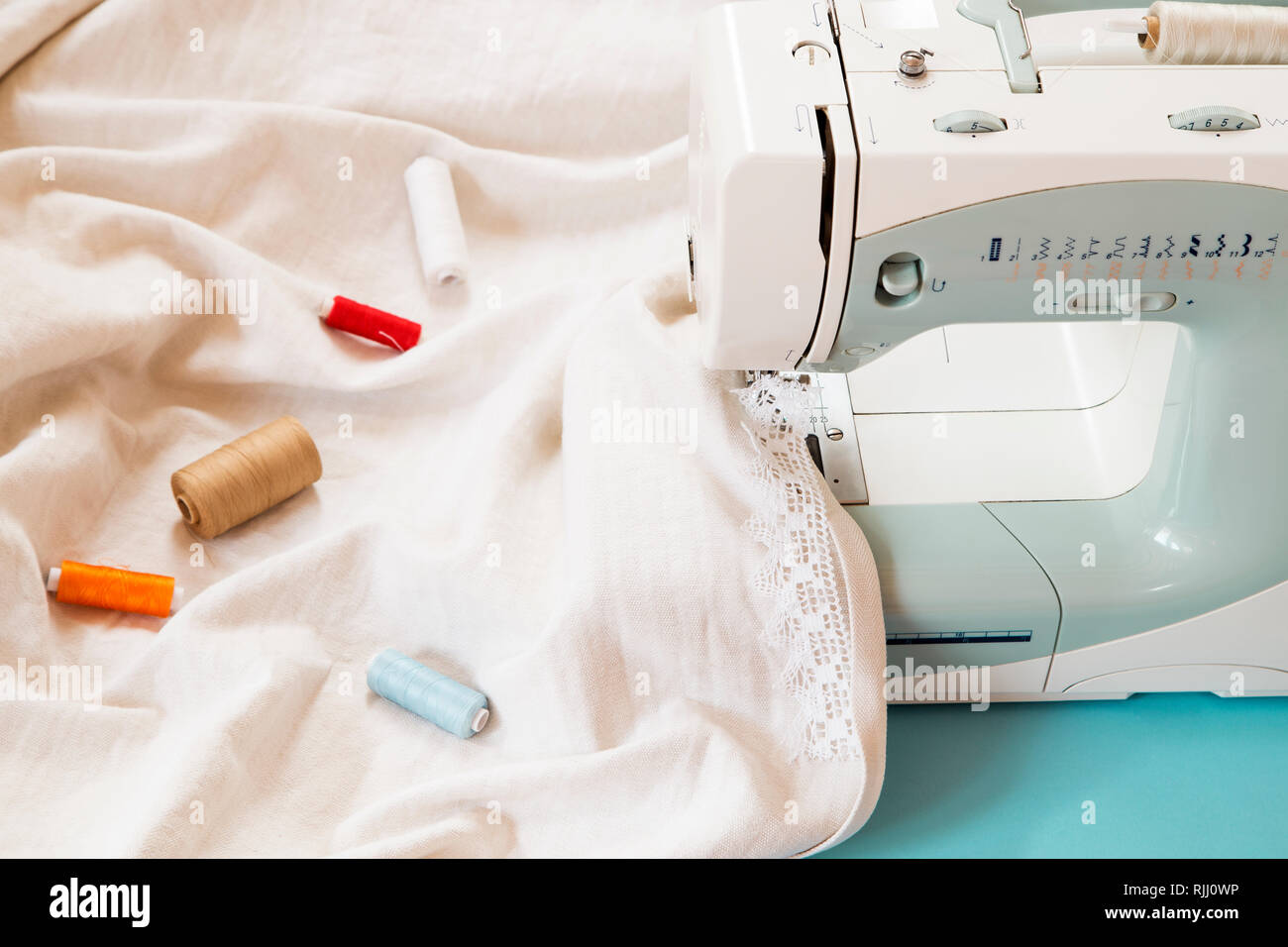 Sewing machine with lace, cotton and threads Stock Photo - Alamy