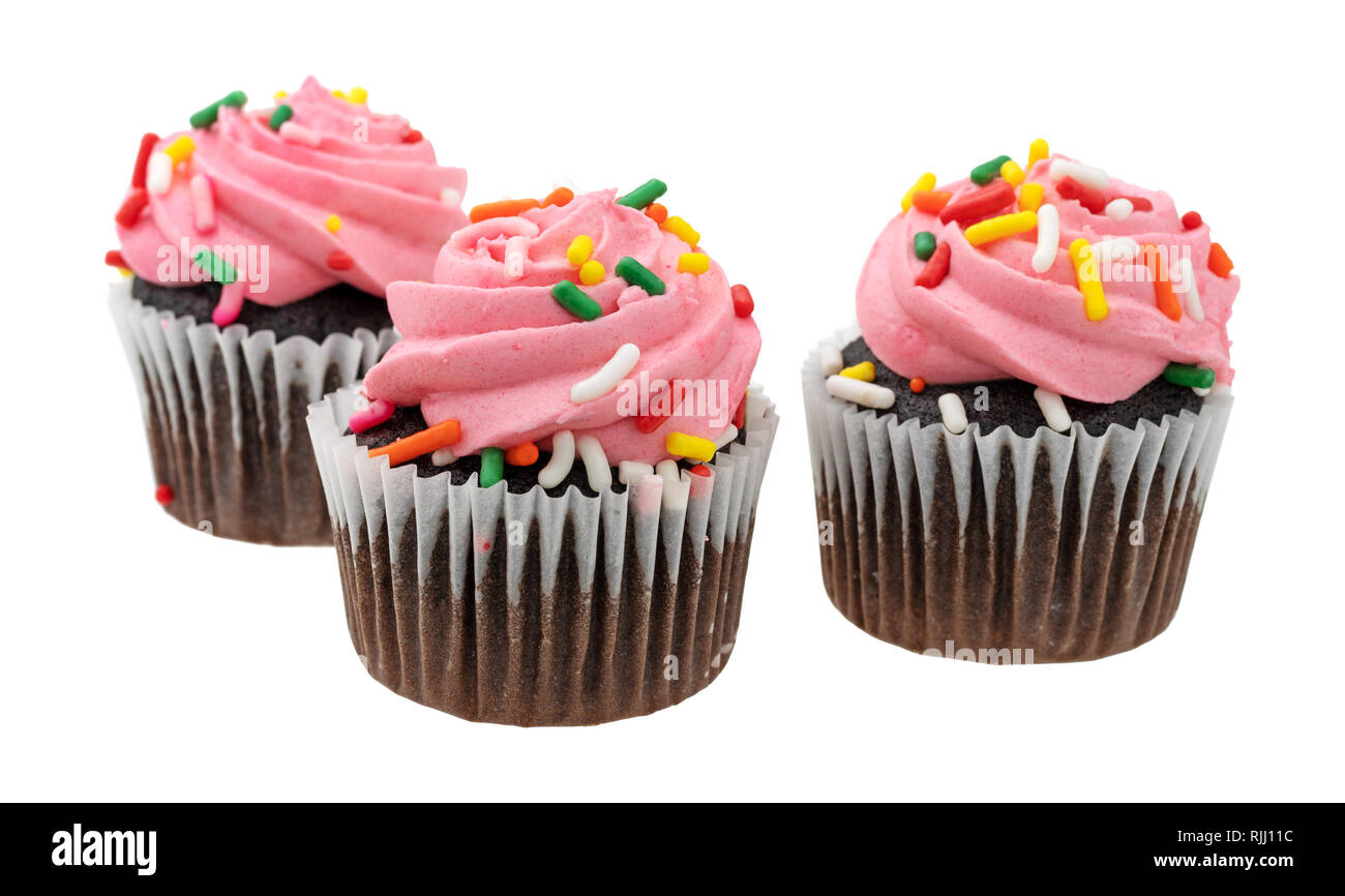 Side view of three pink frosted chocolate cupcakes isolated on a white ...