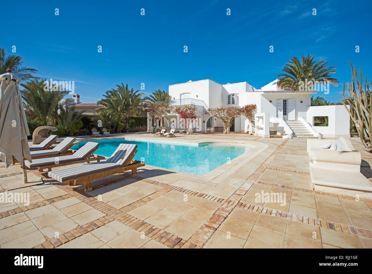 Luxury villa show home in tropical summer holiday resort with outdoor ...