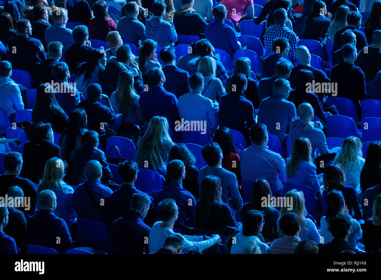 Audience listens to the lecturer at the business conference, back view ...