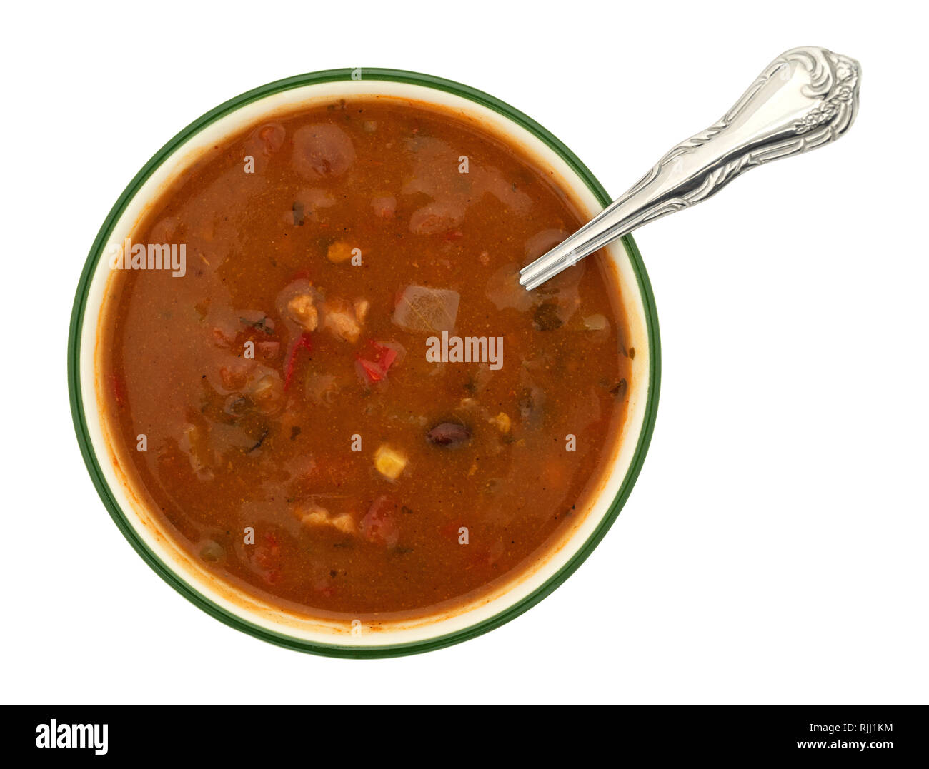 Overhead view of a bowl of chicken tortilla soup with a spoon in the ...