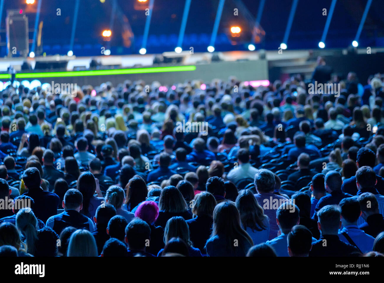 Audience listens to the lecturer at the business conference, back view ...