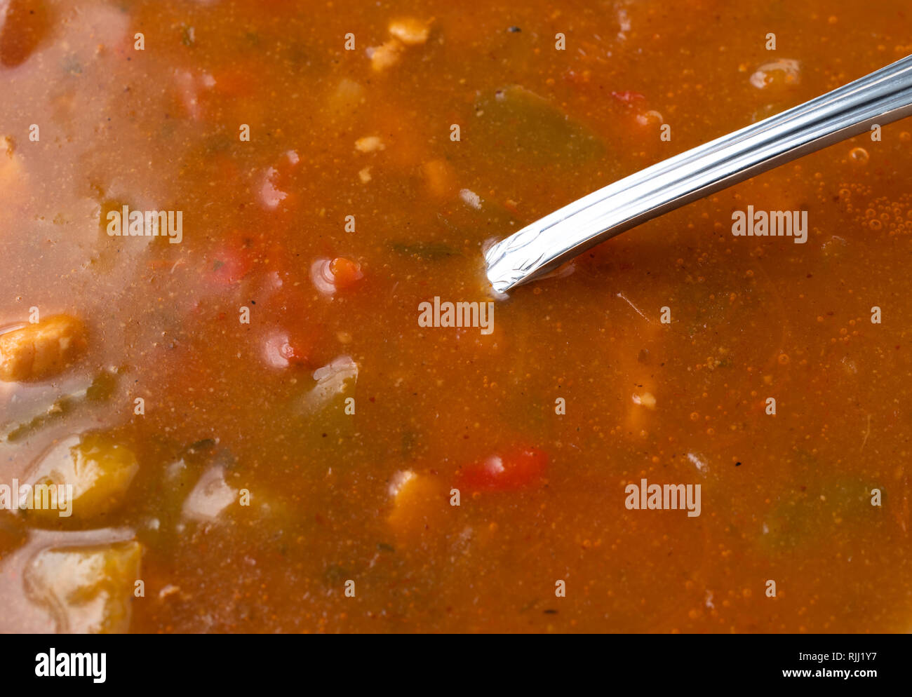 Side view of chicken tortilla soup with a metal spoon in the food Stock ...