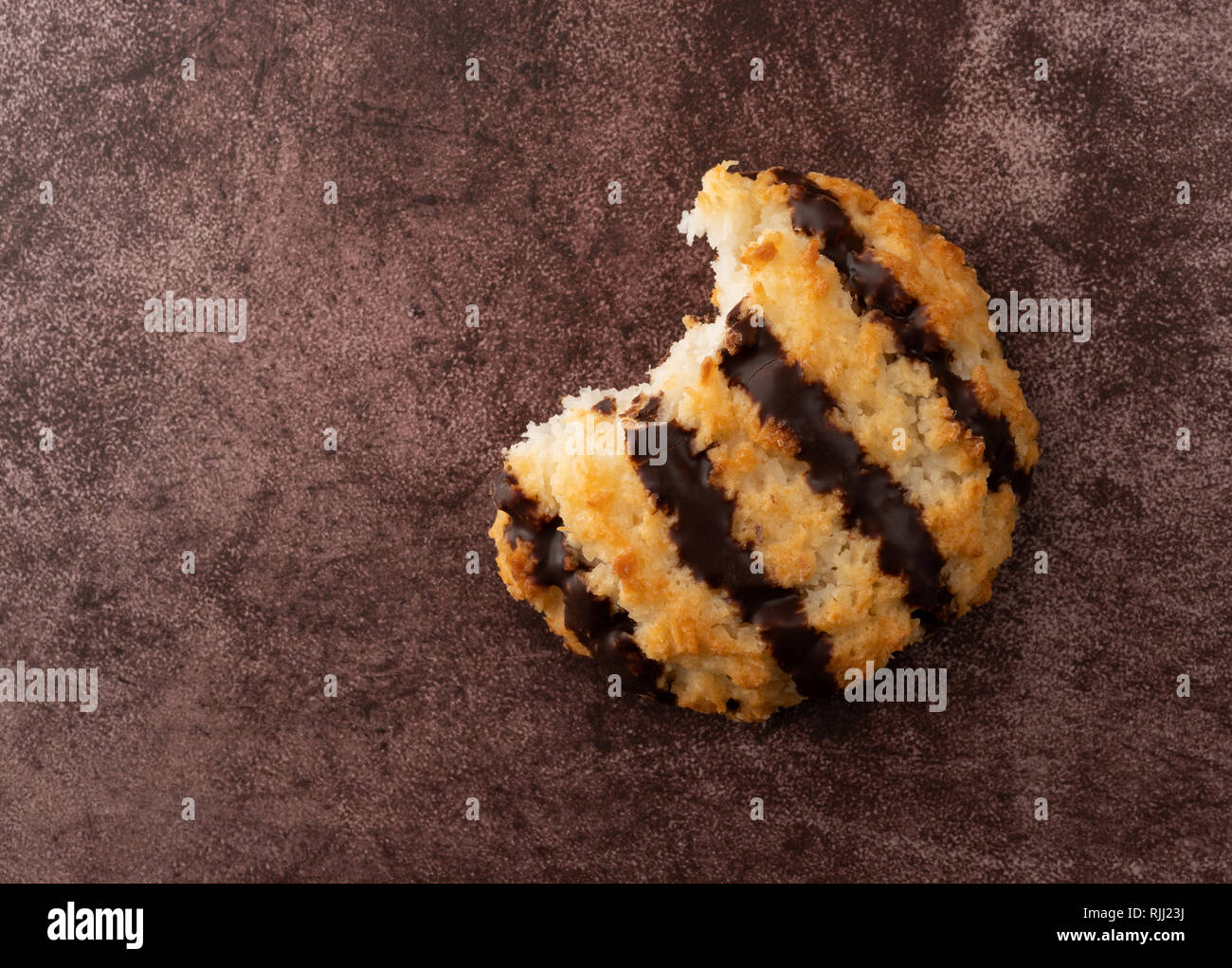 Overhead view of a single dark chocolate striped coconut macaroon ...