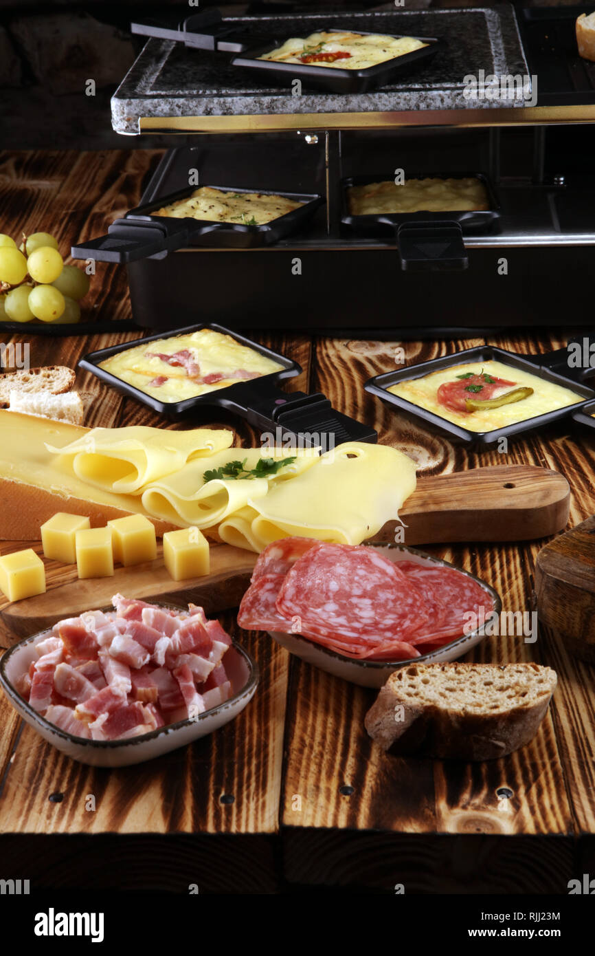 Delicious traditional Swiss melted raclette cheese served in individual ...